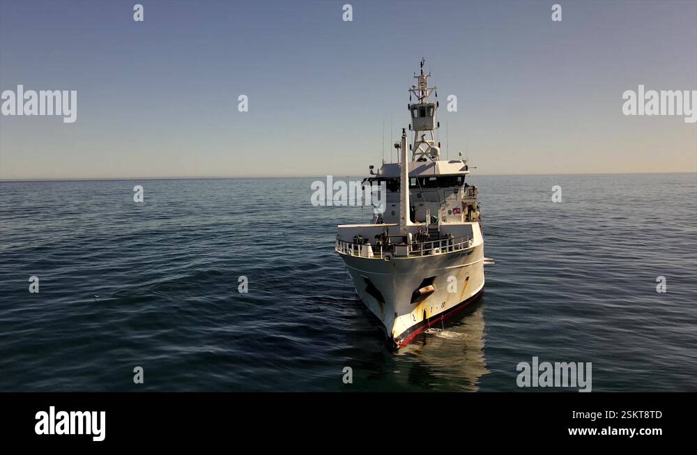 Marine research vessel seen from the bow using its crane on the open ...