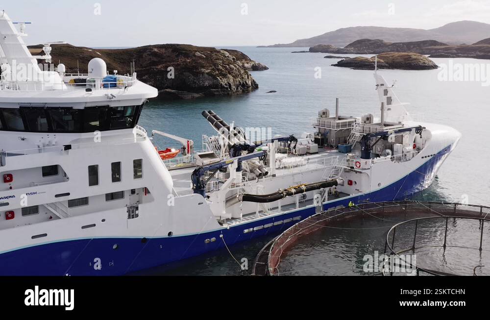 Ascending drone shot of the deck on a fish farming vessel by a fish ...