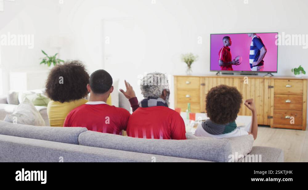 Biracial family watching tv with diverse male rugby players with ball on screen Stock Video ...