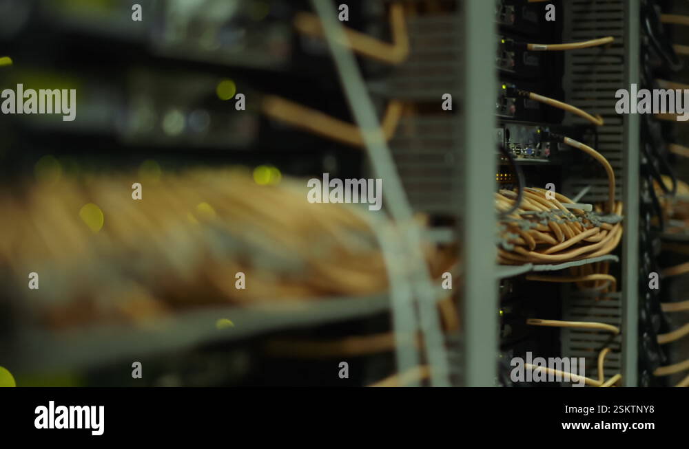 Pan to left of computer server deck rack cables and blinking lights in ...