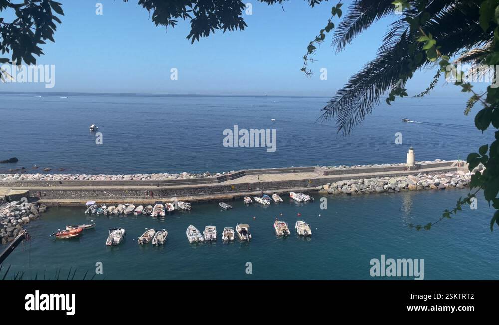 Sea view and the boats mooring behind the seawall in Camogli, Italy ...