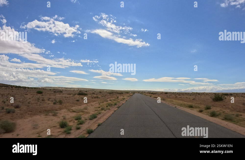 Looking back while driving along a road in the Mojave Desert - hyper ...