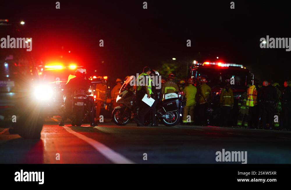Police and firefighters at a accident scene, nighttime in Los Angeles ...