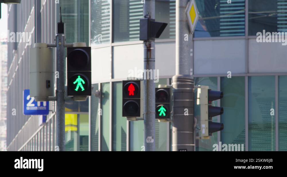Three traffic lights at a pedestrian crossing changing colours in a row ...