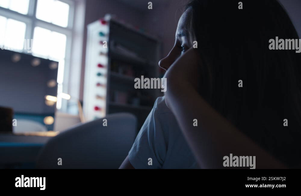 Depressed Teenage Girl Lying On Bed At Home Looking At Mobile Phone ...
