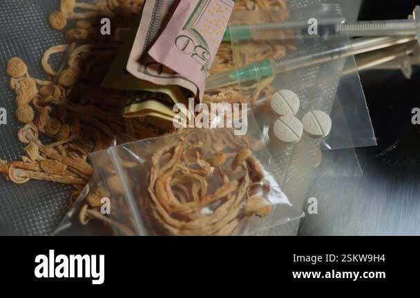 Table of drug dealer with Magic mushrooms, fentanyl pills in pressed ...