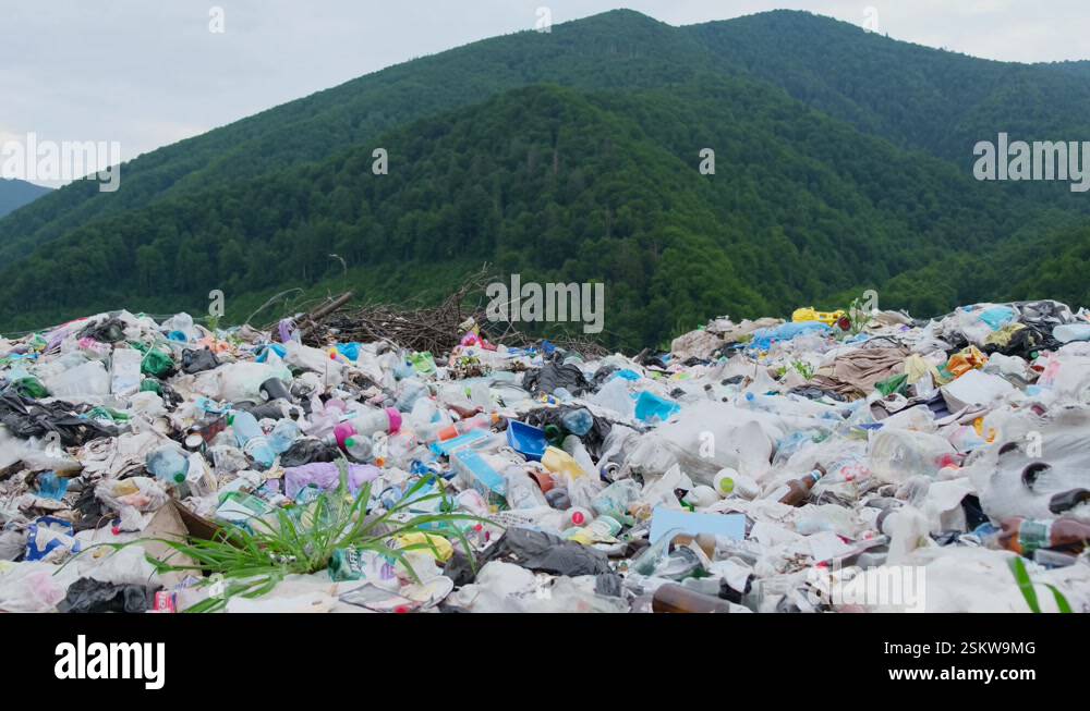 A landfill in the middle of beautiful mountains and forest. Landfill of ...