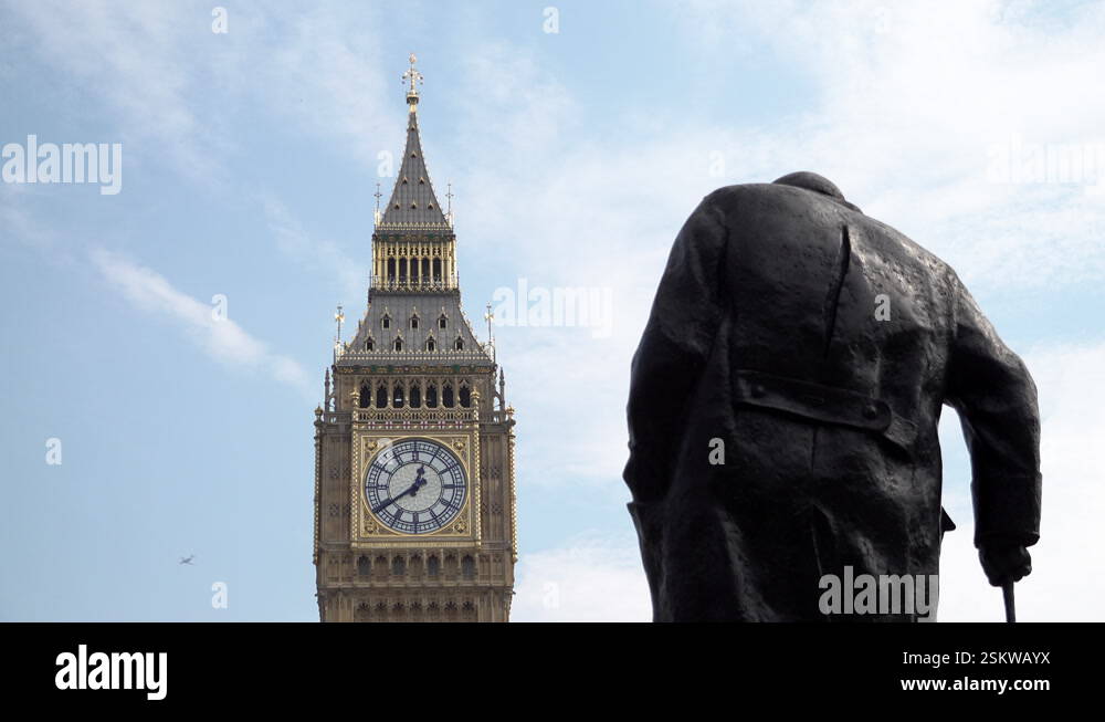 A private jet plane flies behind the Winston Churchill statue on Stock ...