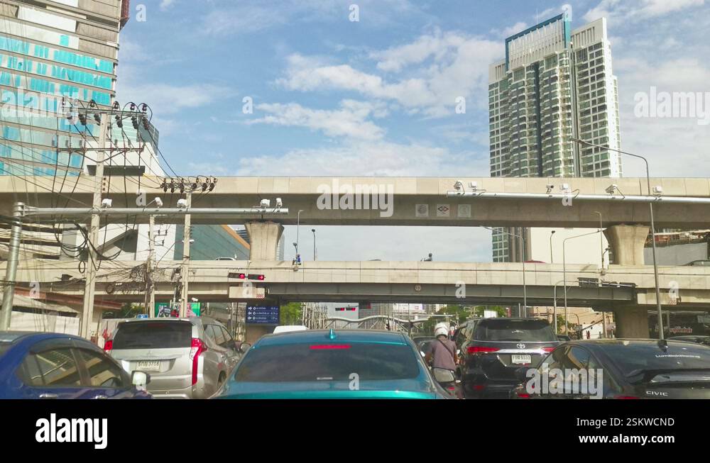 Beautiful Day with a BTS Skytrain Line Crossing Over at an Intersection Stock Video Footage - Alamy