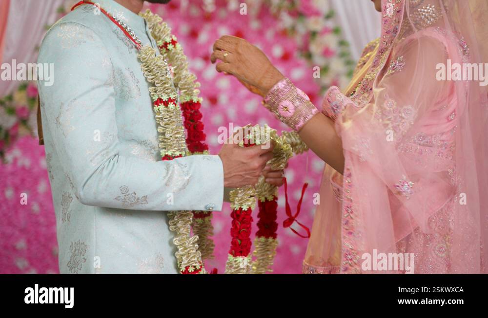 Close up of Indian Wedding Bride and groom Exchanging garlands during ...