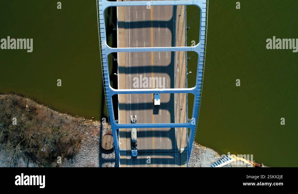 Aerial Top Forward View Of Vehicles On Bridge Over River In City During ...