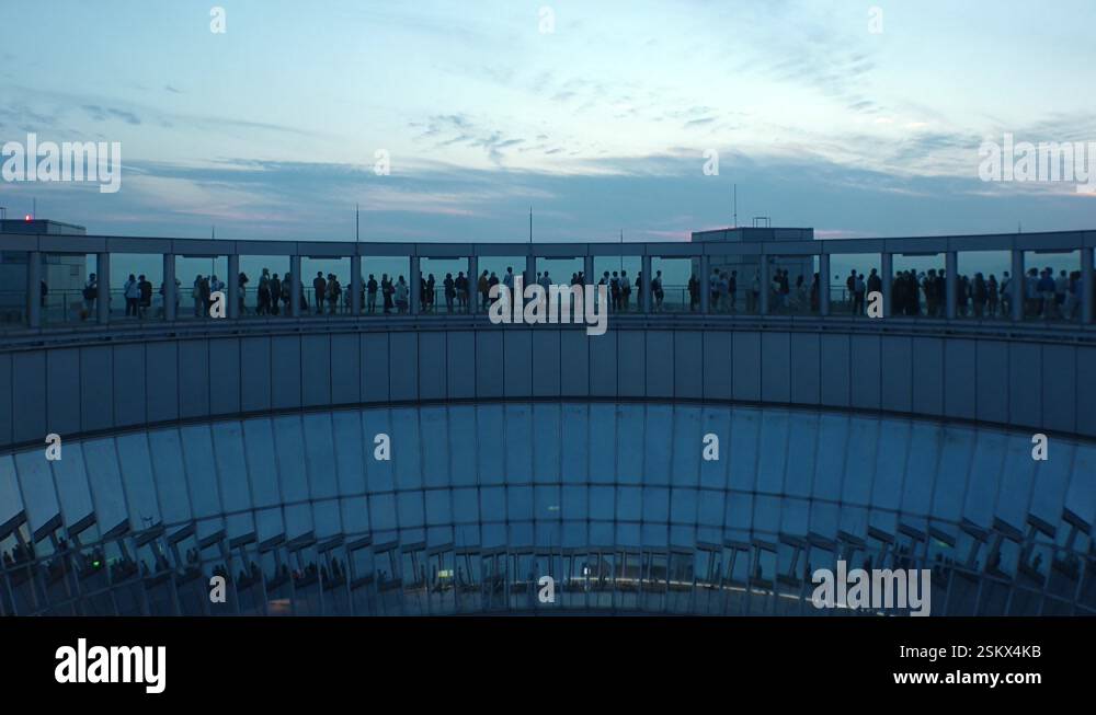 Time lapse shot of crowd of people at the observation deck in sunset ...