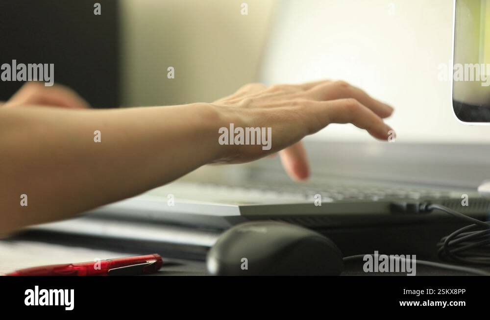 Slow motion footage of person using information technology to do their ...