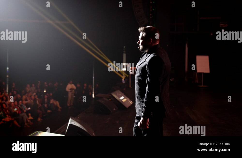 psychology and motivation coach performing on stage in large hall ...