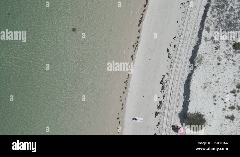 Towel laid out on the sand while the owner goes for a swim at a ...