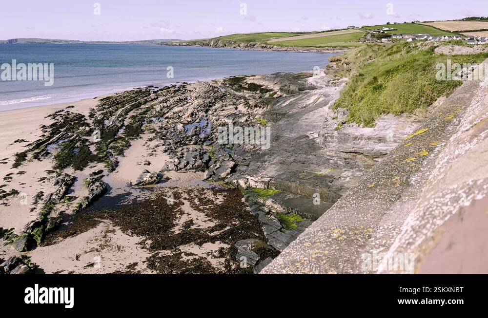 Coastal area in county Cork, with rocks and cliffs and sandy beach on ...