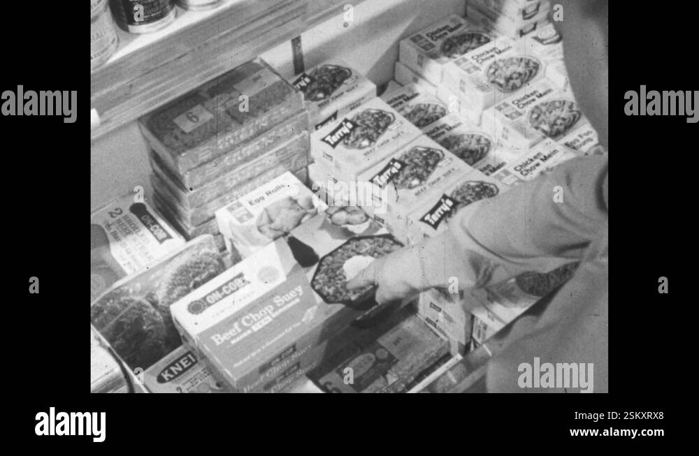 1960s: Man and boy look over a frozen food display. Boy points to a ...