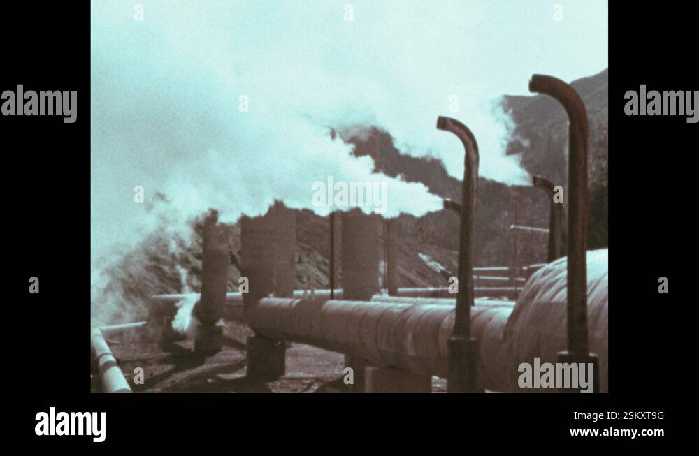 1980s: Steam rises from a geothermal plant. Man turns a valve. Steam ...