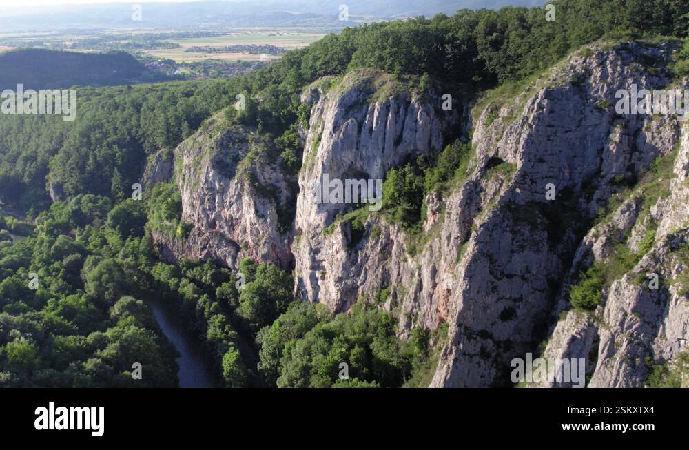 River next to giant limestone rock cliffs with a harsh sun Stock Video ...