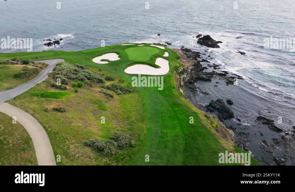 push in aerial drone shot from the tee box to the green of the iconic ...