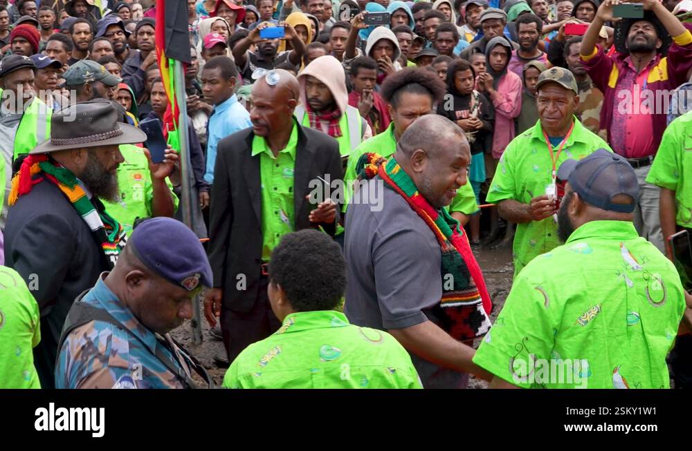 Papua New Guinea Prime Minister walks through crowd greeting and ...
