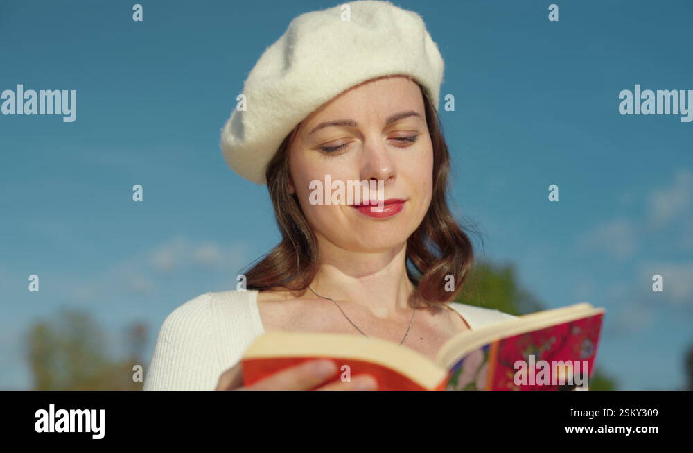 Young girl reading a book in the park, Paris Stock Video Footage - Alamy