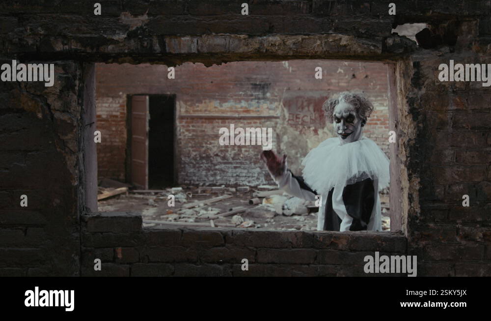 Crazy Clown Greeting Viewer and Going down Imaginary Ladder behind Wall ...