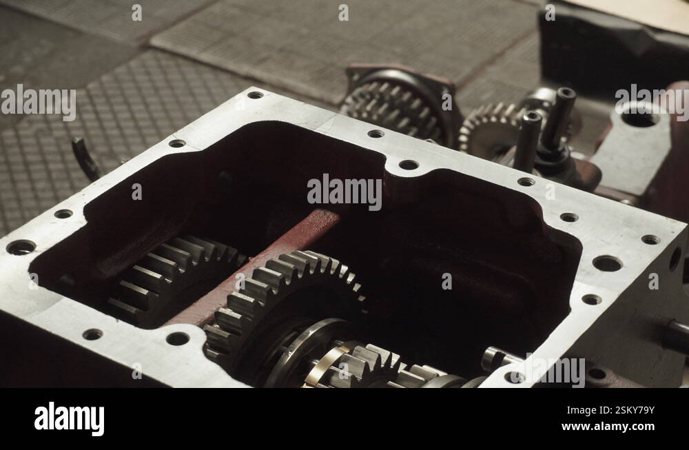 Open gearbox housing with rotating gears inside during quality control ...