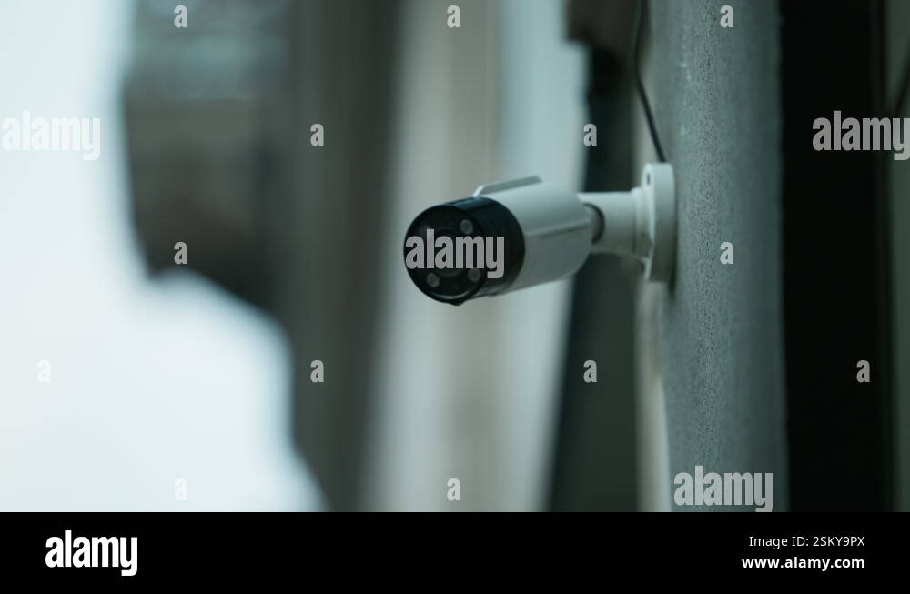 Modern CCTV camera captured in establishing shot on building wall Stock ...