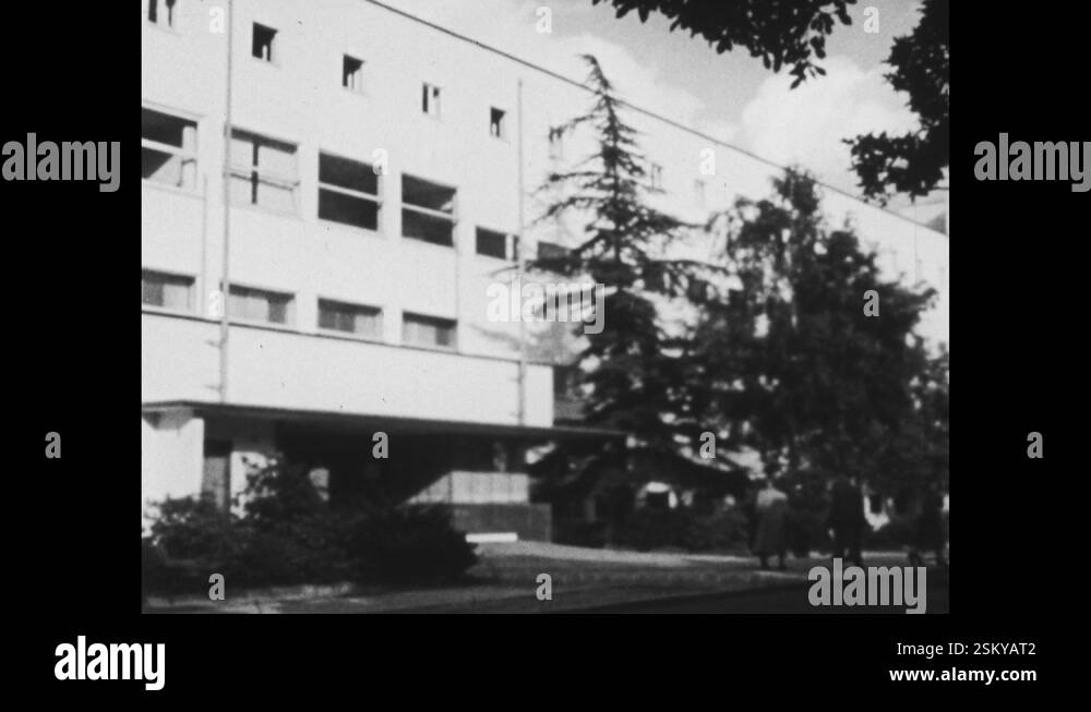 1960s: Exterior shots of buildings. Flags on flag poles. Map of Europe ...