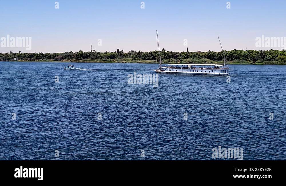 The Nile River. Tugboat and barge navigating the river. Nile river bank ...