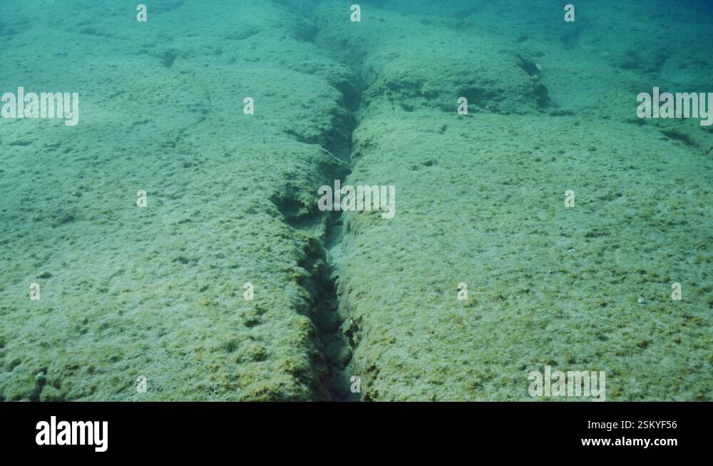Camera moving forwards above crack in seabed over tectonic plates Stock ...