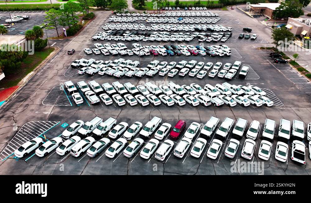 Flying low over a parking lot full of Unmarked Police cars black white ...