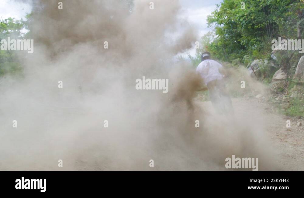 Cinematic slomo of a mountain biker blowing up a berm on a trail Stock ...