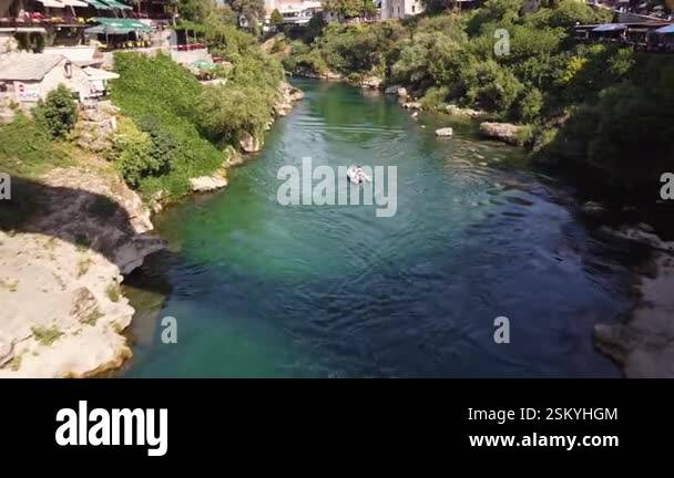 Tourist activity of boat ride in the Neretva river passing under the ...