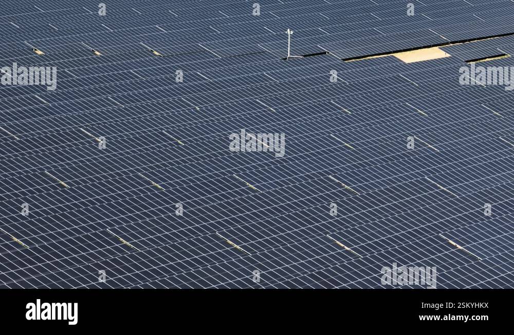 solar panel aerial view revealing green renewable energy farm with wind ...