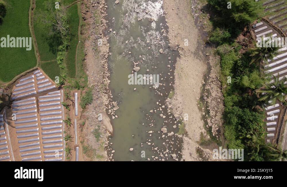 Top down view of small water stream on the big rocky river during dry ...