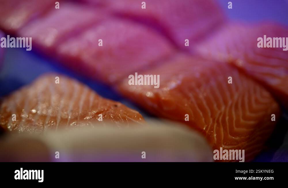 The cooking process is a close-up. Slicing juicy fresh red salmon fish ...