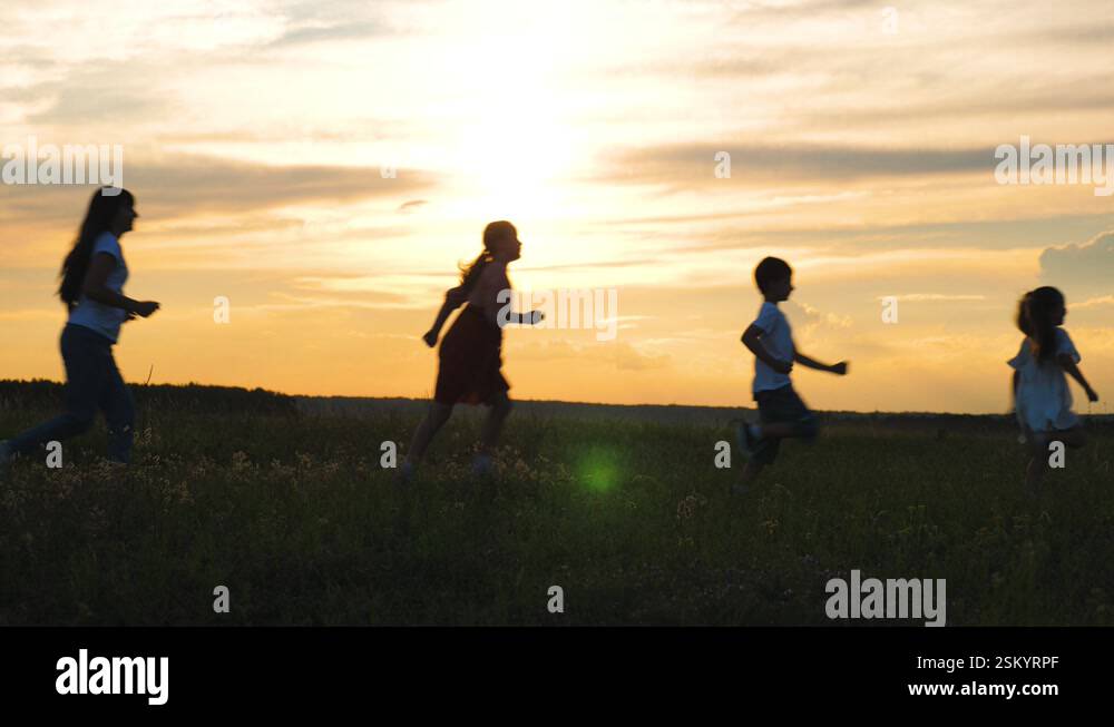 Cute children and active parents run having fun in rural field at sunset time Stock Video ...