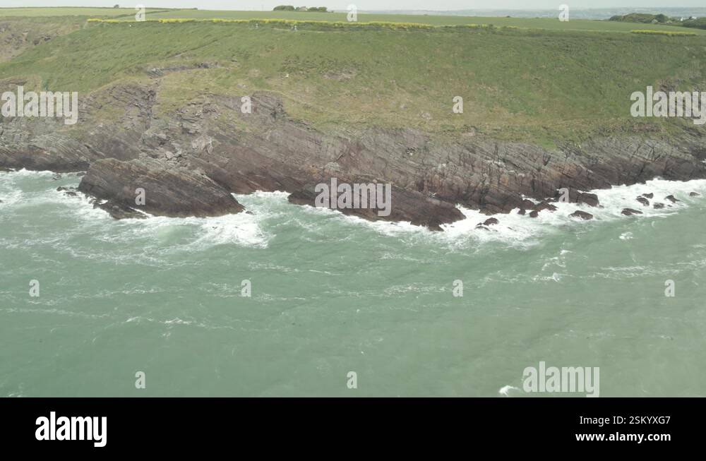 Ocean Waves Crashing On Rocky Cliffs In Ballycotton, County Cork ...