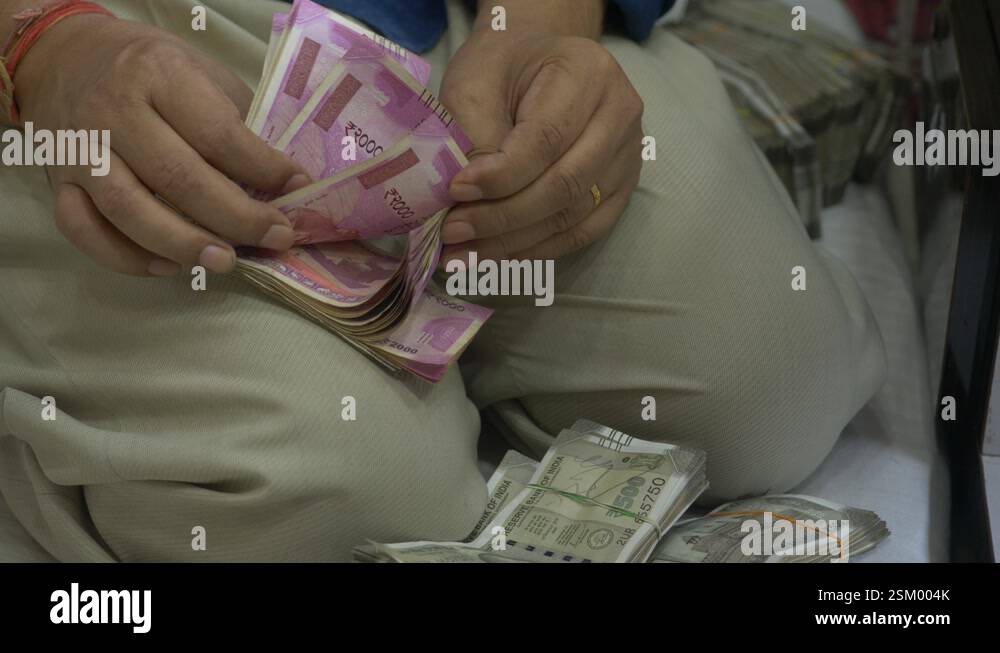 Hand counting 2000 rupee Indian banknotes, Indian currency in hand ...
