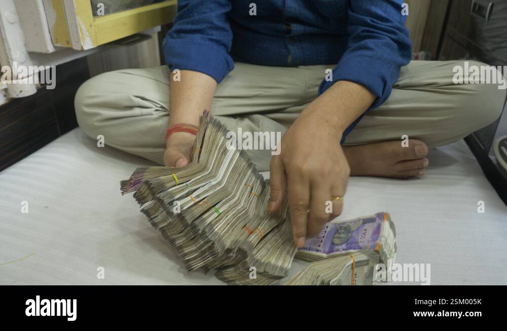 A businessman counting stack of Indian banknotes, Cash in hand, Lots of ...