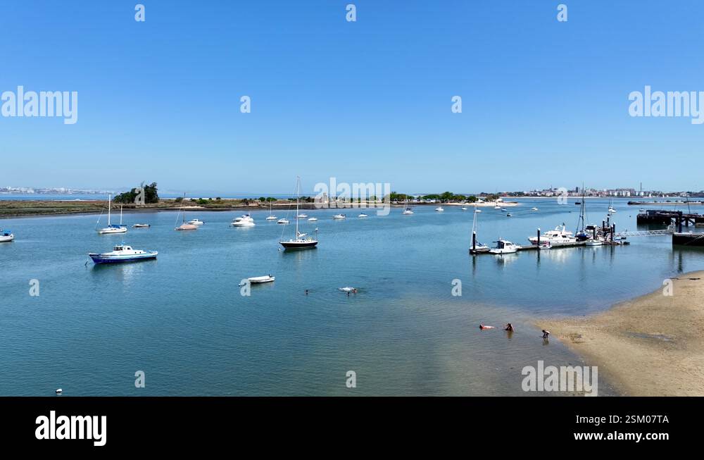 Drone shot - flying over the water and filming anchored sail boats and ...