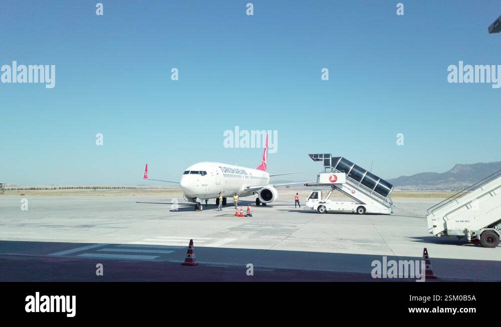 In the daytime at Denizli Cardak Airport apron, a stair truck connects ...