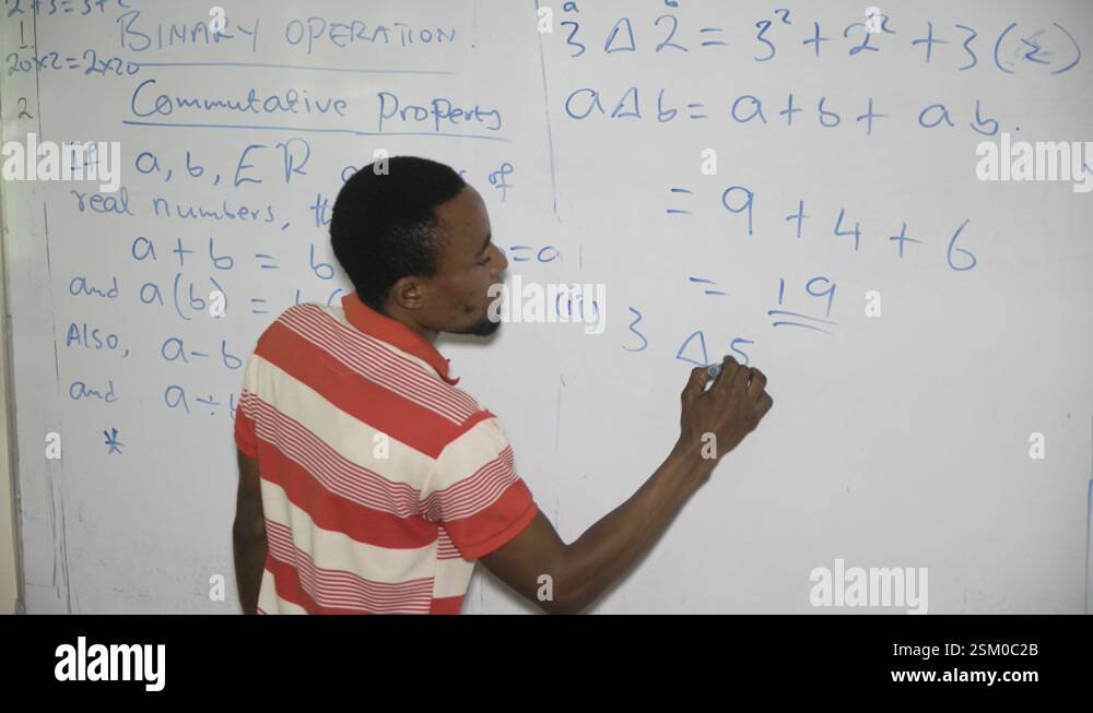 Math’s teacher explaining arithmetic sums to elementary children Stock ...