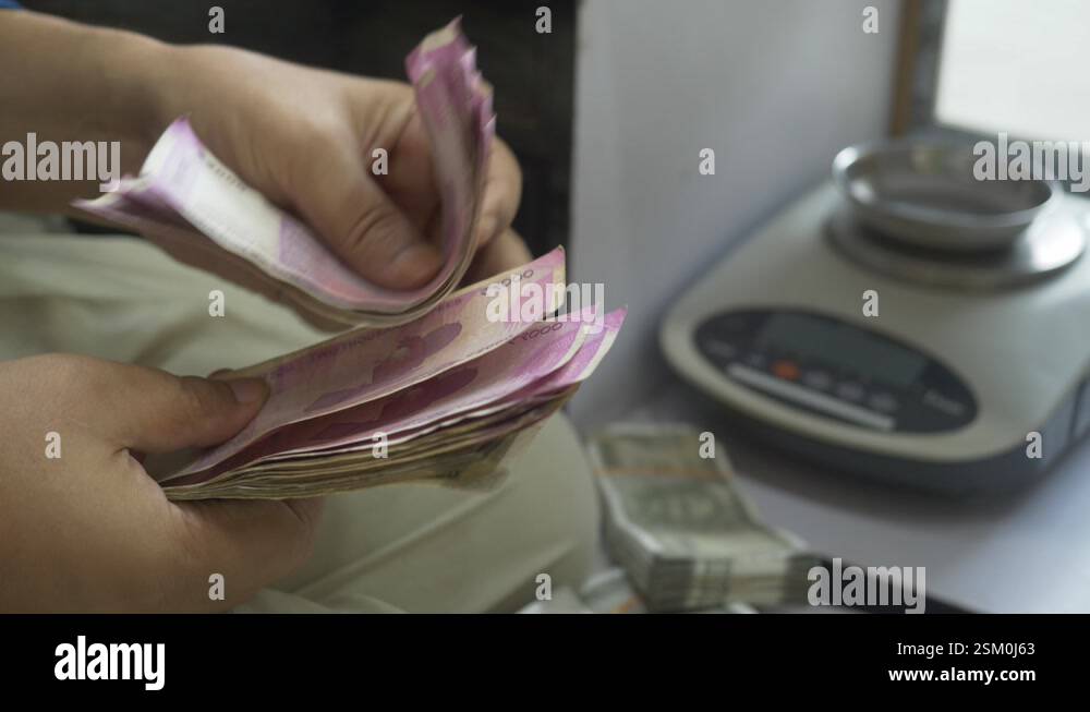 A business counting 2000 Indian rupee banknotes, Cash in hand counting ...