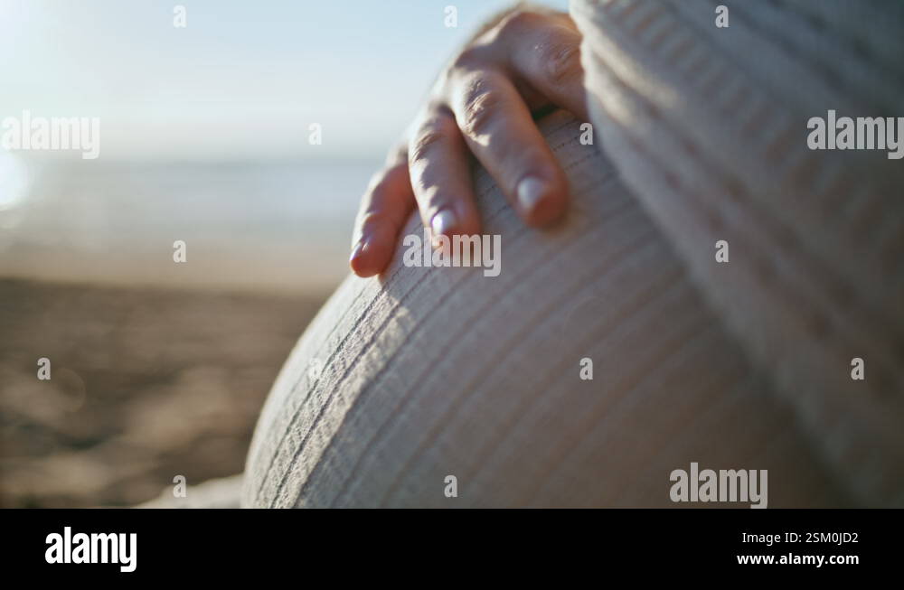 Woman hand caressing belly expecting baby close up. Pregnant tummy at ...