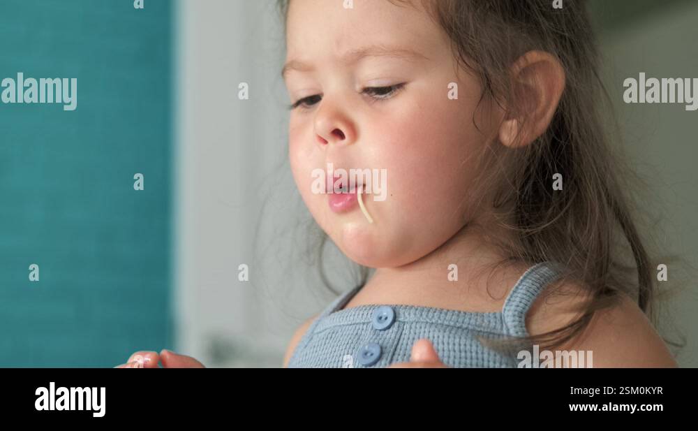 Adorable toddler girl eat pasta spaghetti, happy preschool child eating ...