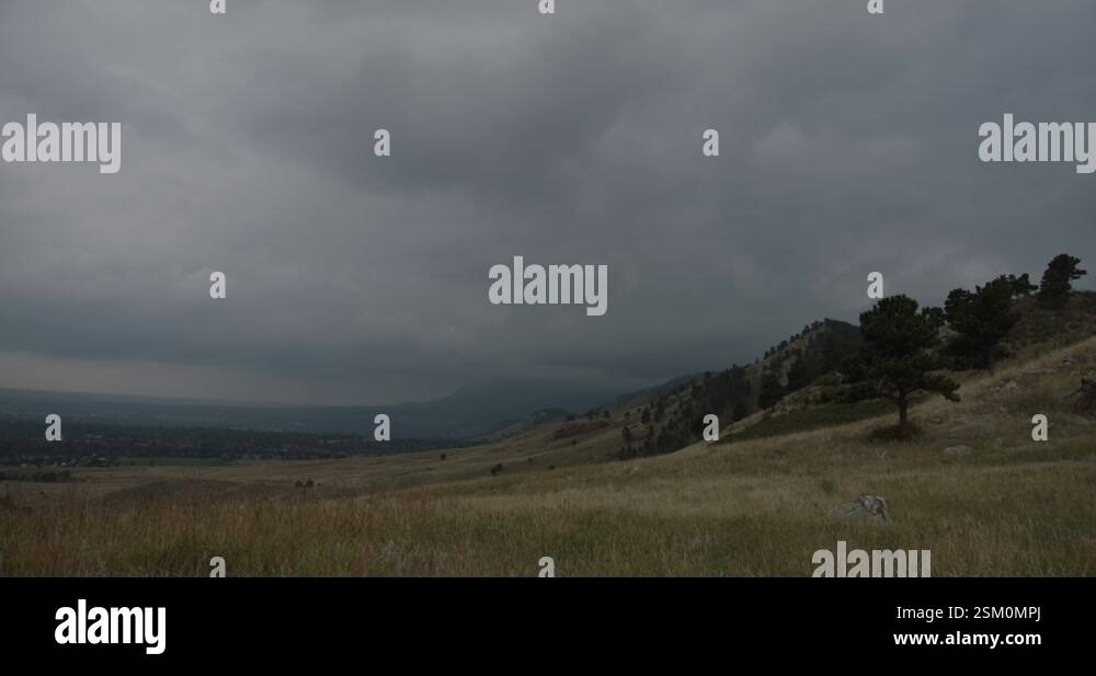 Cloudy mountain hike in Colorado with a wide view of hillside and open ...