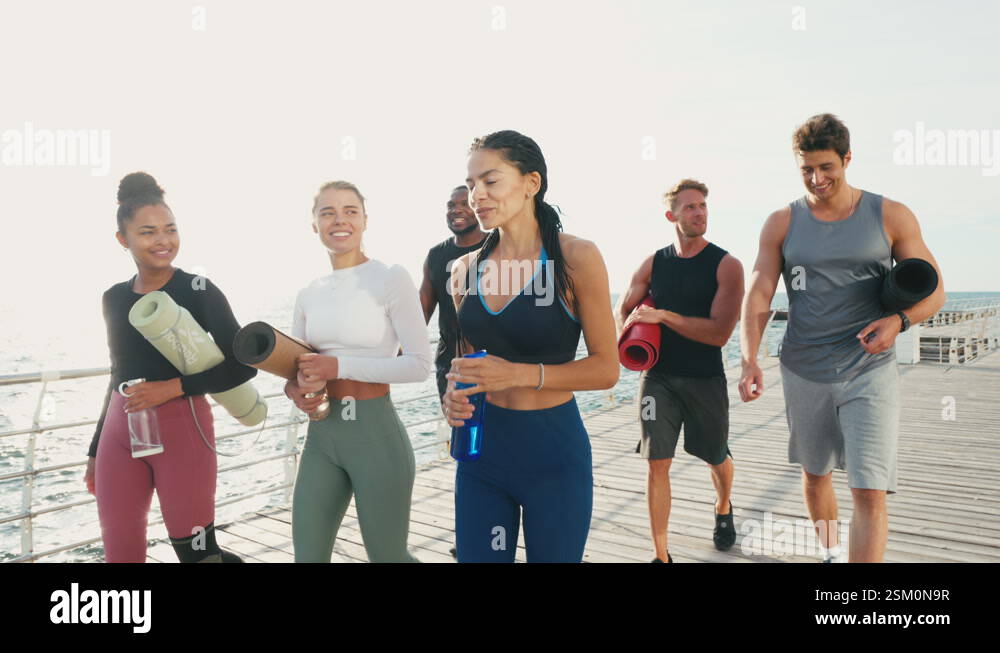 Tired group of people walk along sea after yoga training Stock Video ...